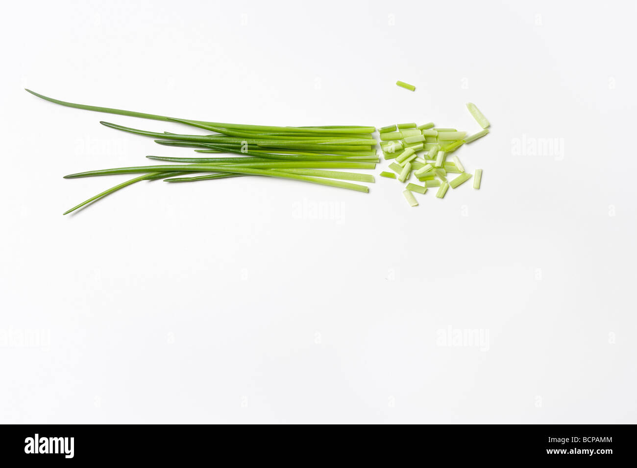 Chives with cut pieces on white background Stock Photo - Alamy
