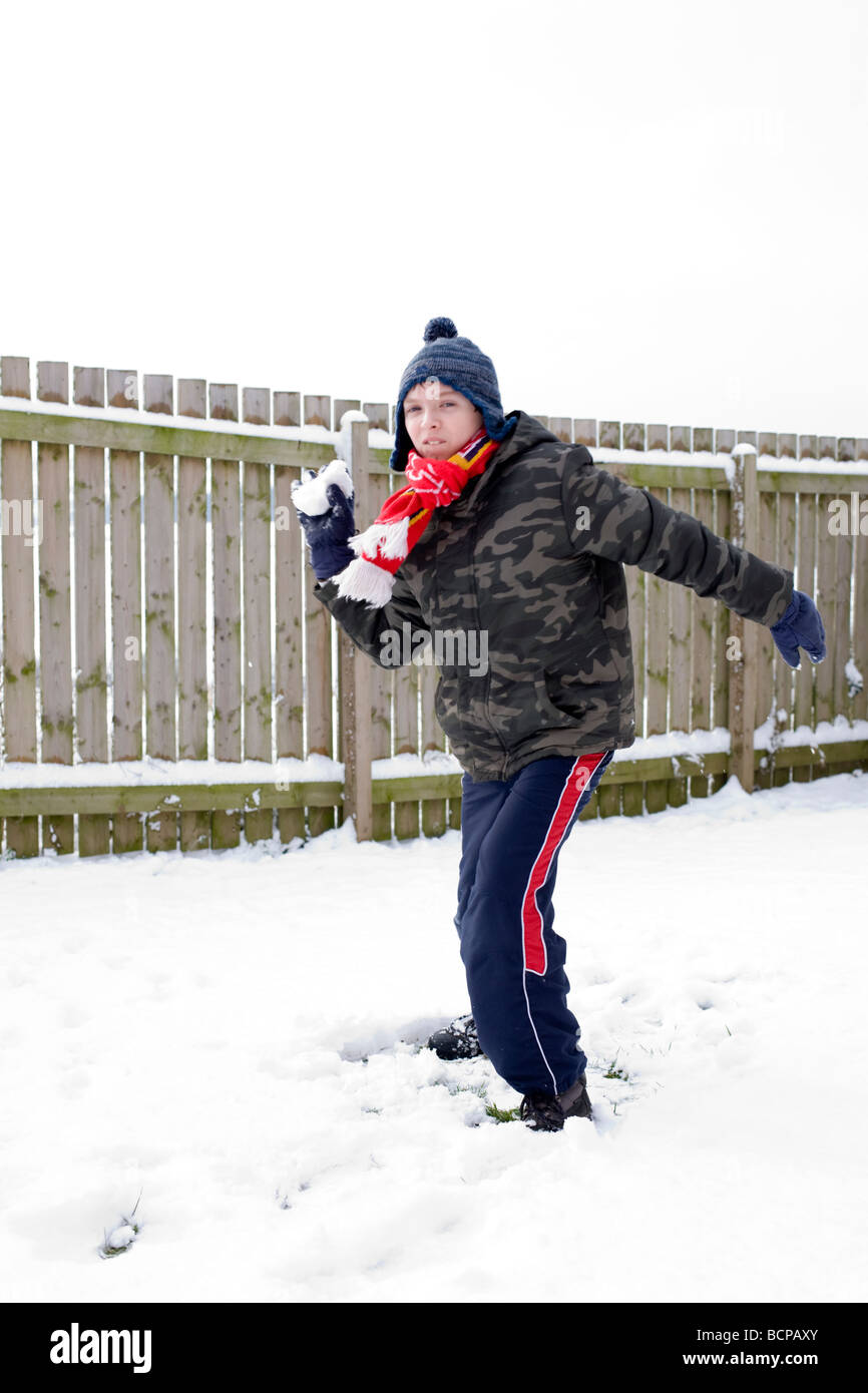 Boy throwing snowball Stock Photo - Alamy