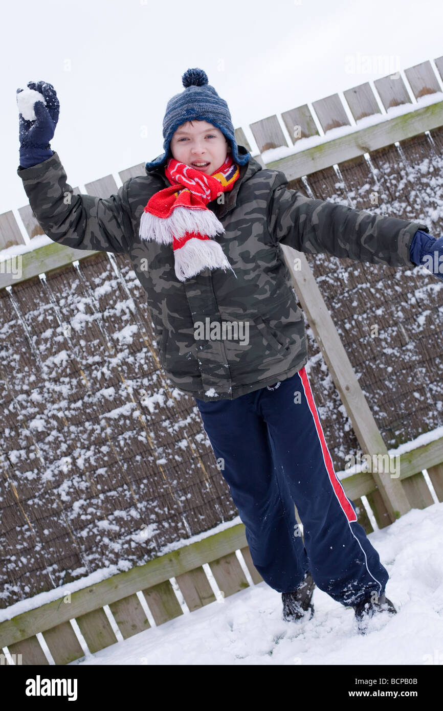Boy throwing snowball Stock Photo - Alamy