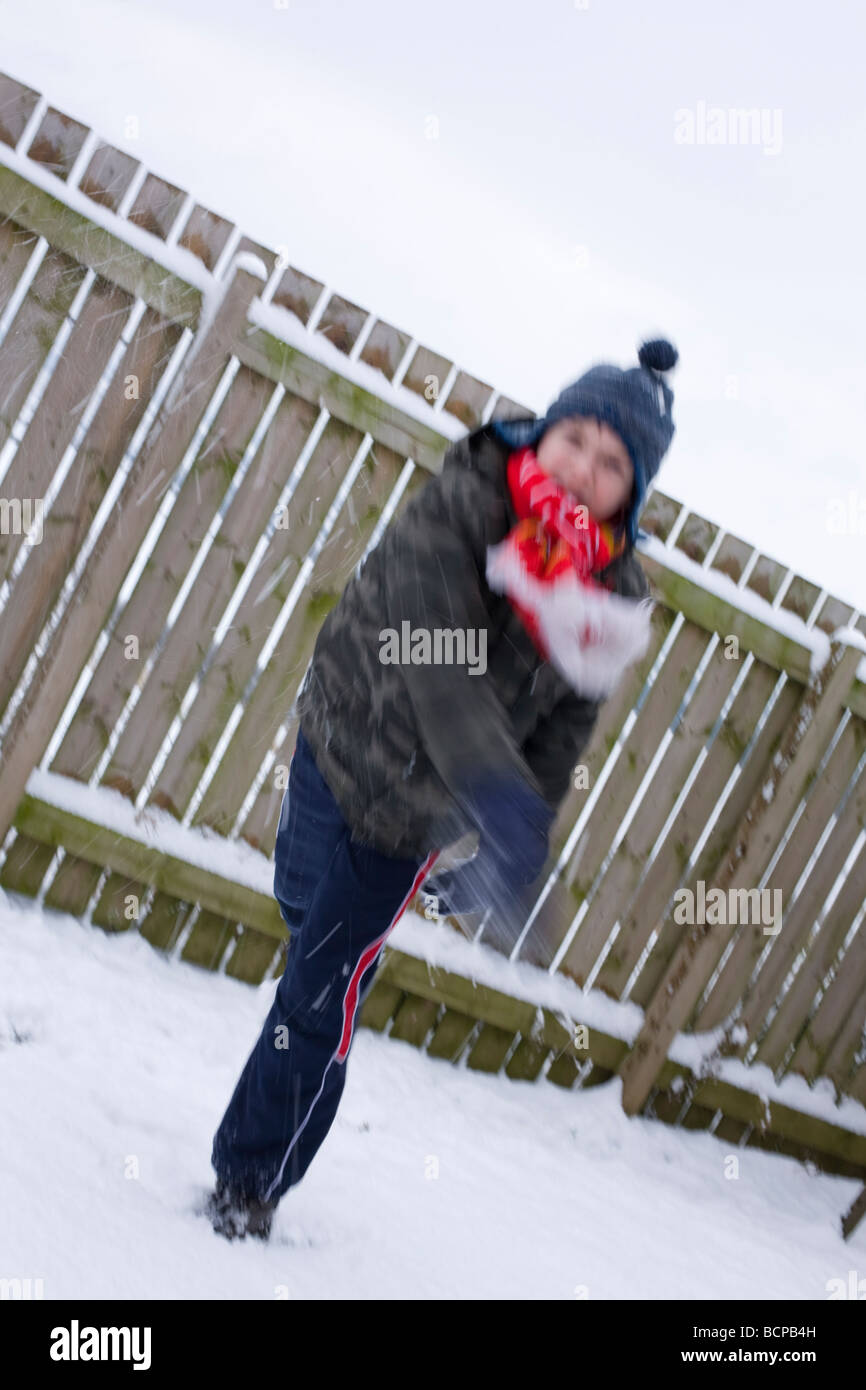 Boy throwing snowball Stock Photo - Alamy