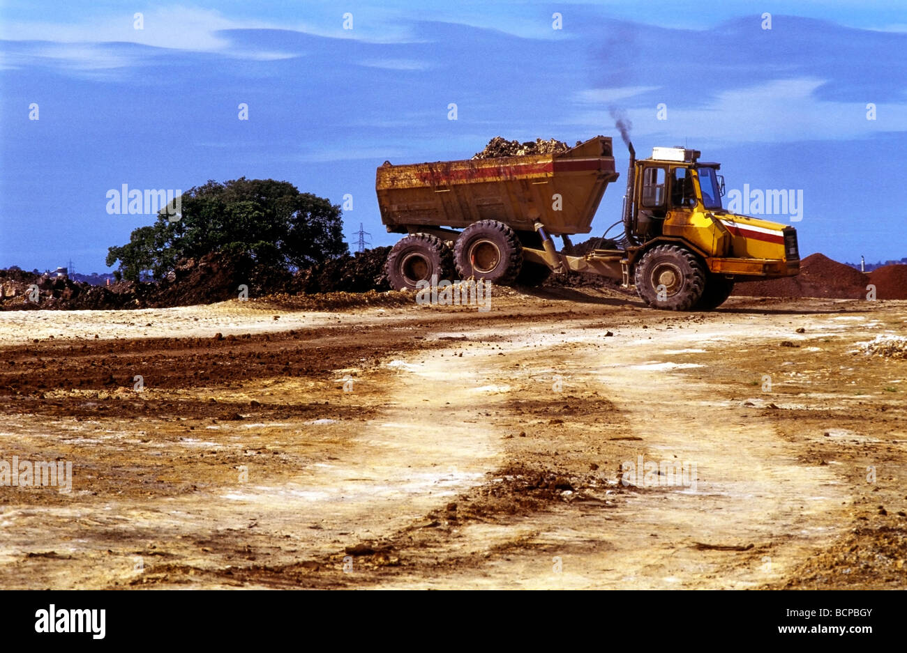 Large dump truck working on a construction site Stock Photo - Alamy