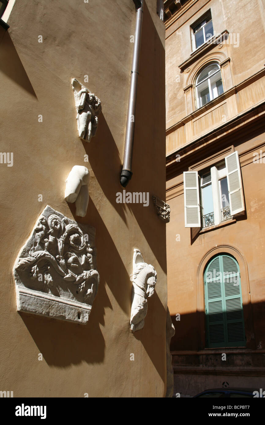 ancient roman relics on property wall near via del corso street in rome ...