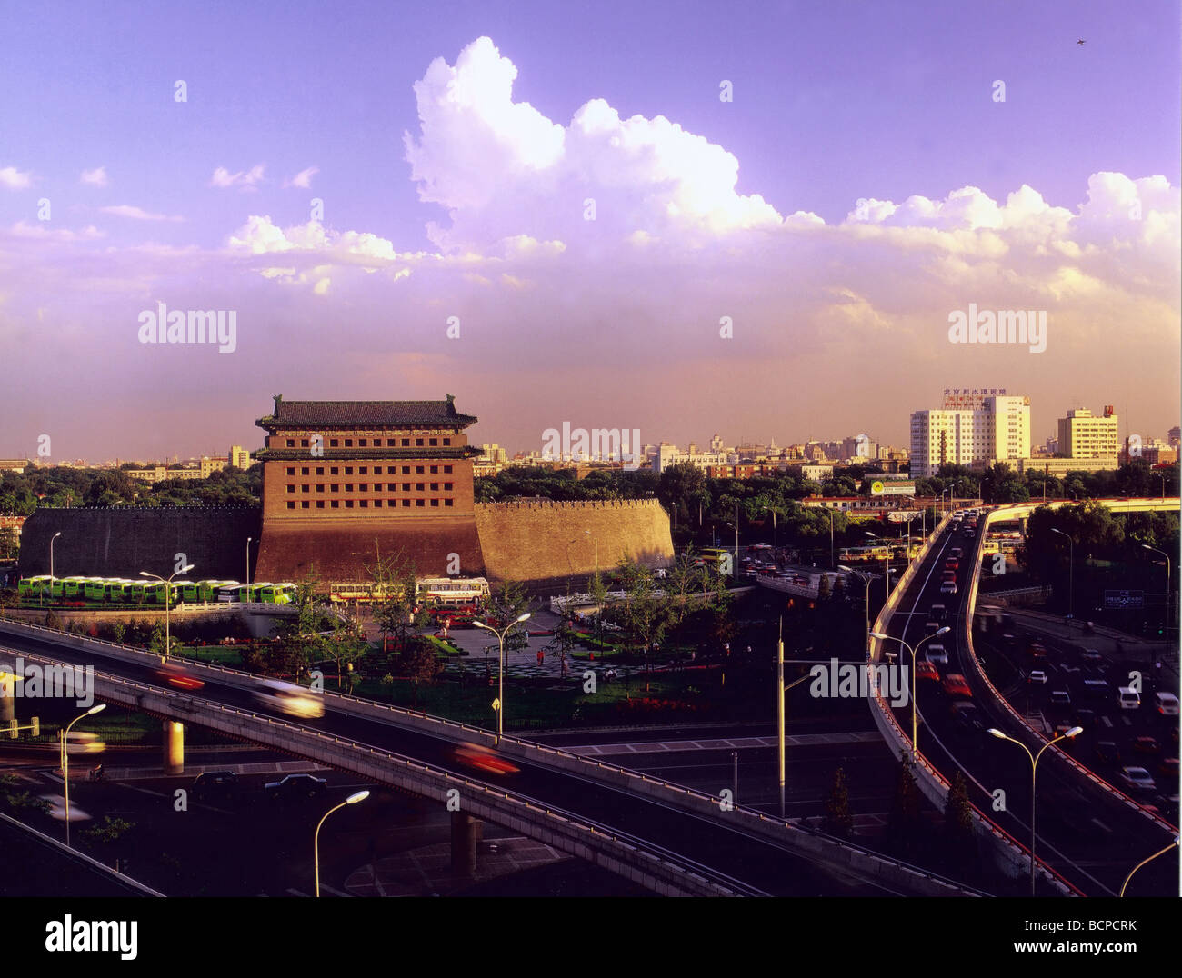 Highways and busy traffic around ancient Deshengmen Gate in sunset ...