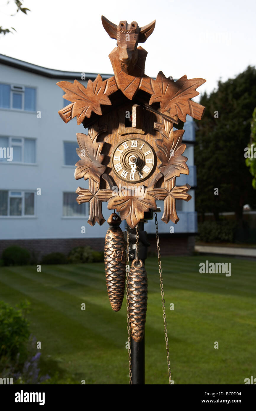 Cuckoo clock on stand, outside a block of flats and green lawn Stock ...