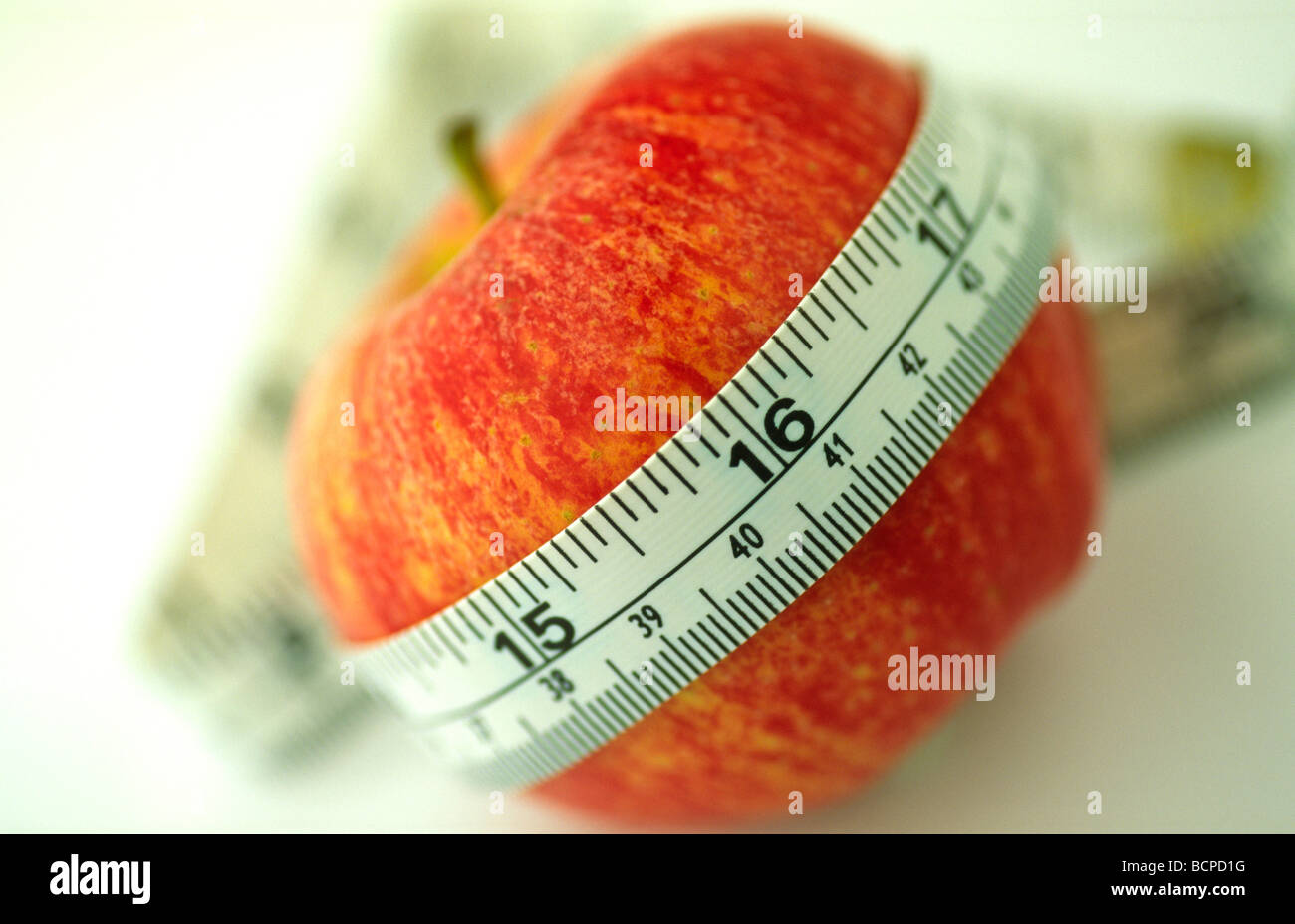 Apple and tape measure Stock Photo - Alamy