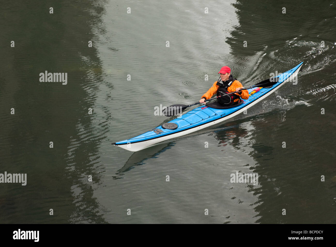 Menai Bridge Anglesey North Wales UK Canoeist paddling a kayak in the ...