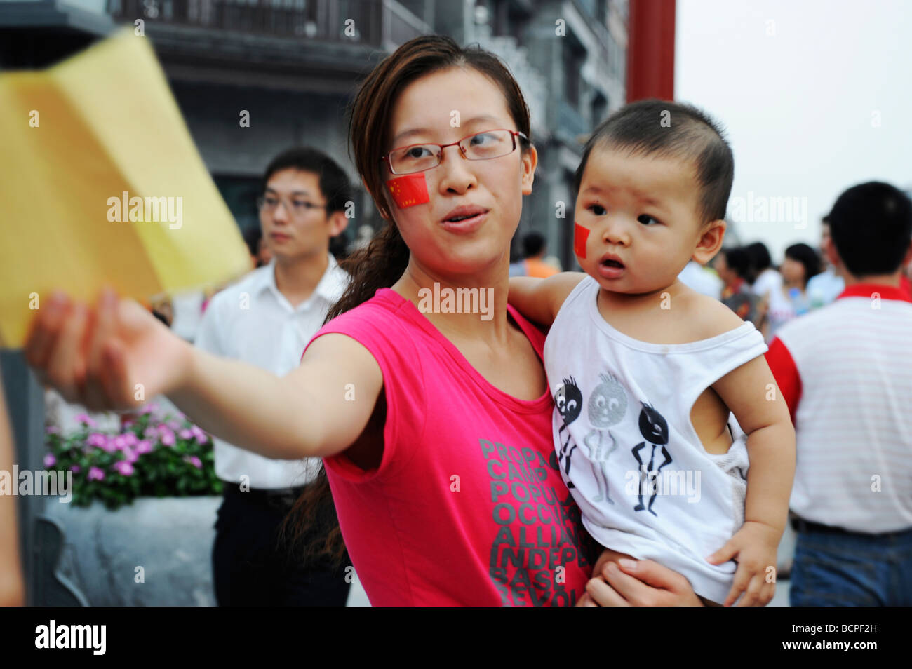 Chinese mother and baby with Chinese national flag stickers on their ...