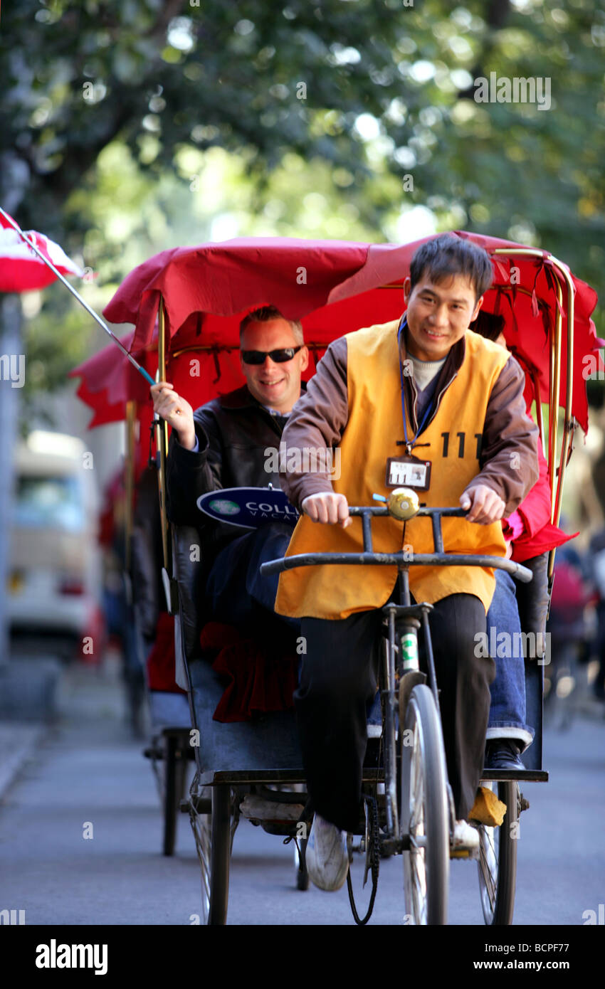 Rickshaw drivers taking tourists for a ride beside Bell Tower and Drum ...