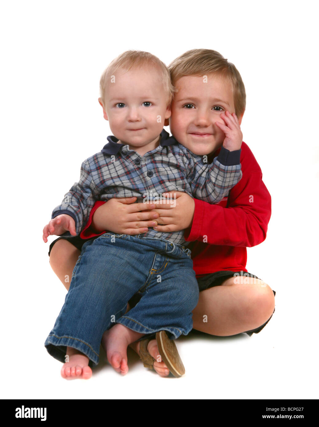 Two Brothers Smiling and Sitting Together Looking at The Viewer Stock ...