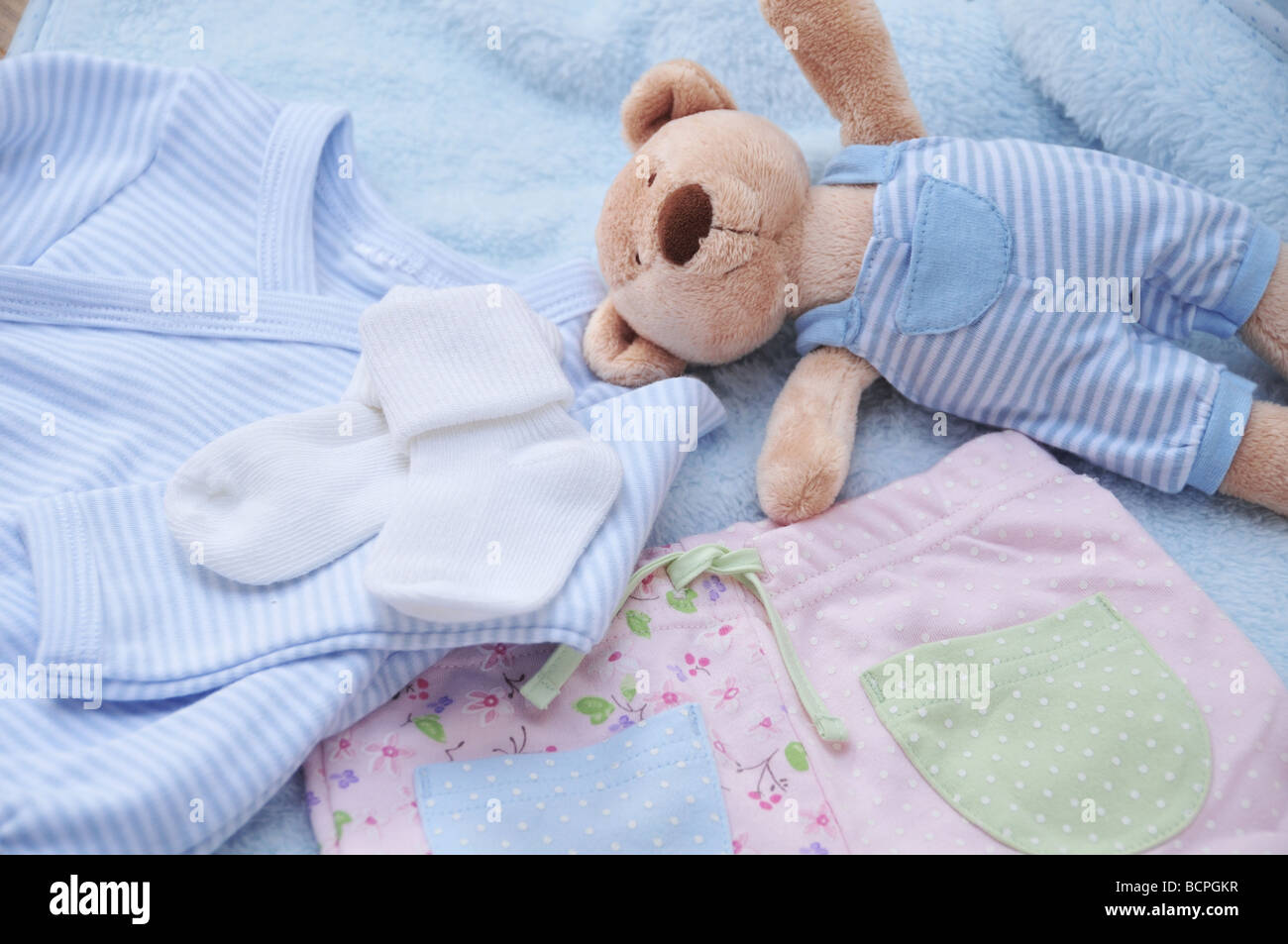Close up of baby clothes with traditional teddy bear Stock Photo - Alamy