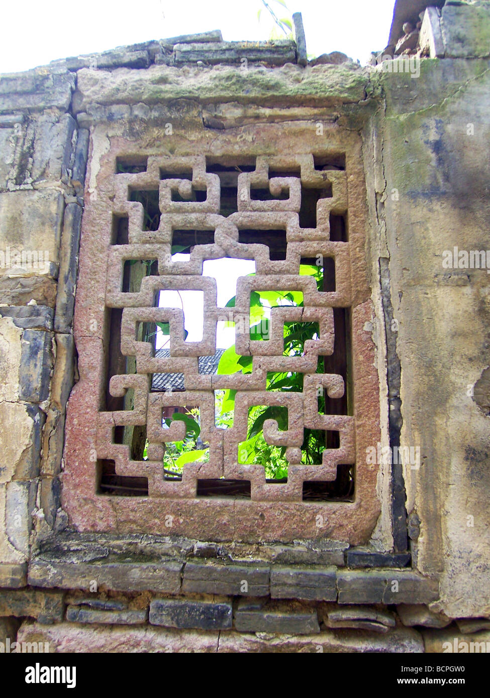 Stone carved lattice window on the stone wall of a traditional ...