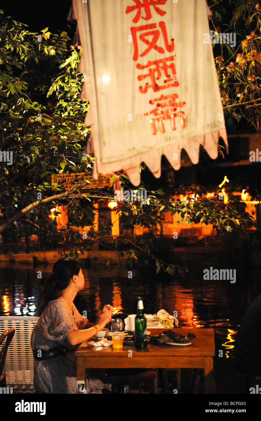 Chinese yong women having dinner along the river, Xitang Town, Zhejiang ...