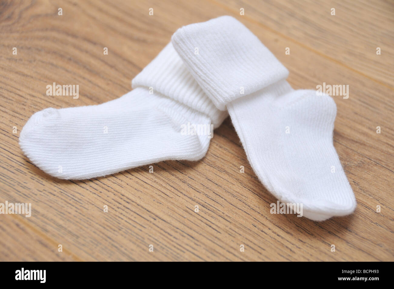 Cute tiny white baby socks Stock Photo - Alamy