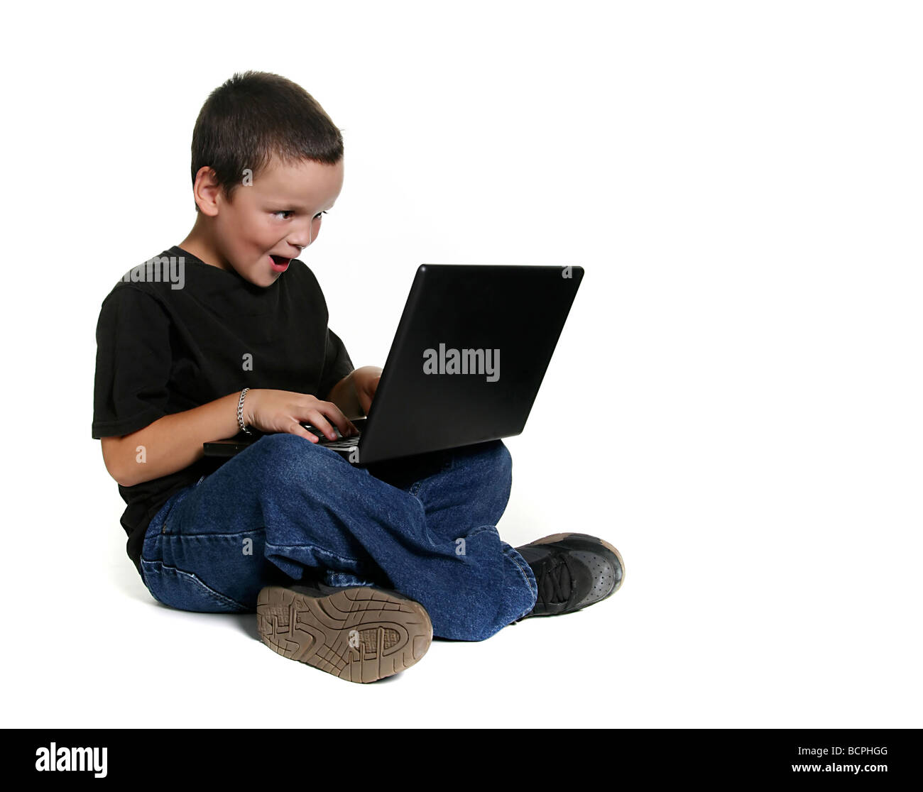 Excited Young Child Working on Computer Stock Photo - Alamy