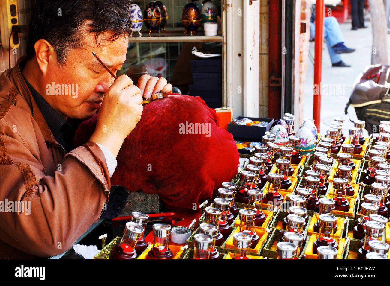 Chinese folk artist creating traditional toy Maohou made with cicada ...