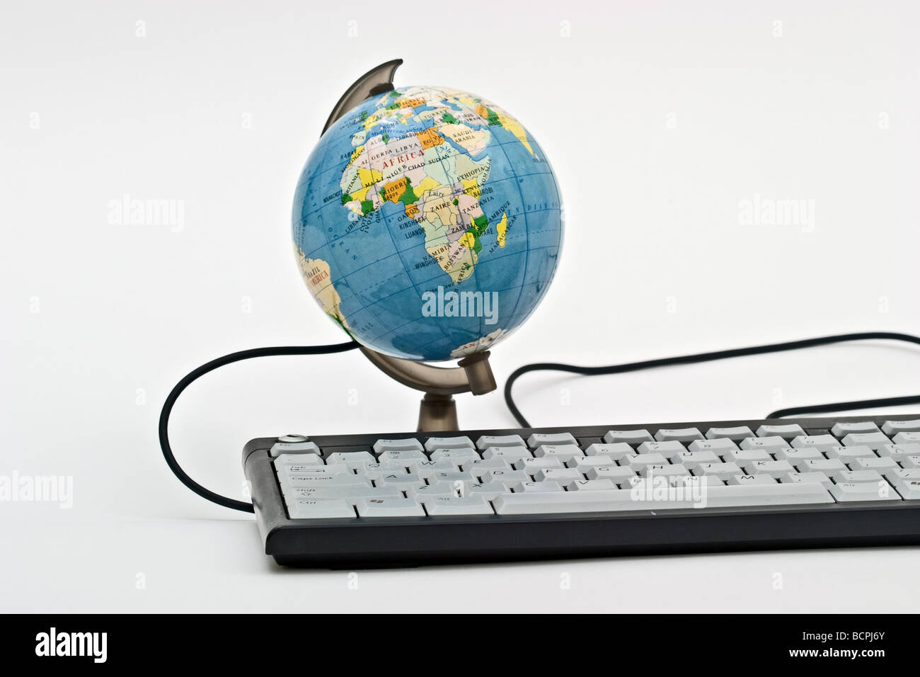 A computer keyboard connected to a globe Stock Photo - Alamy