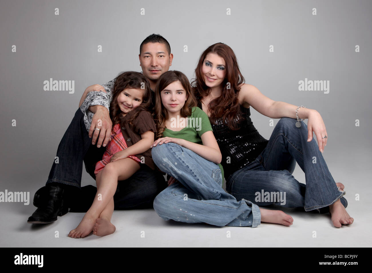 Beautiful Loving Family of 4 on Grey Background Stock Photo - Alamy