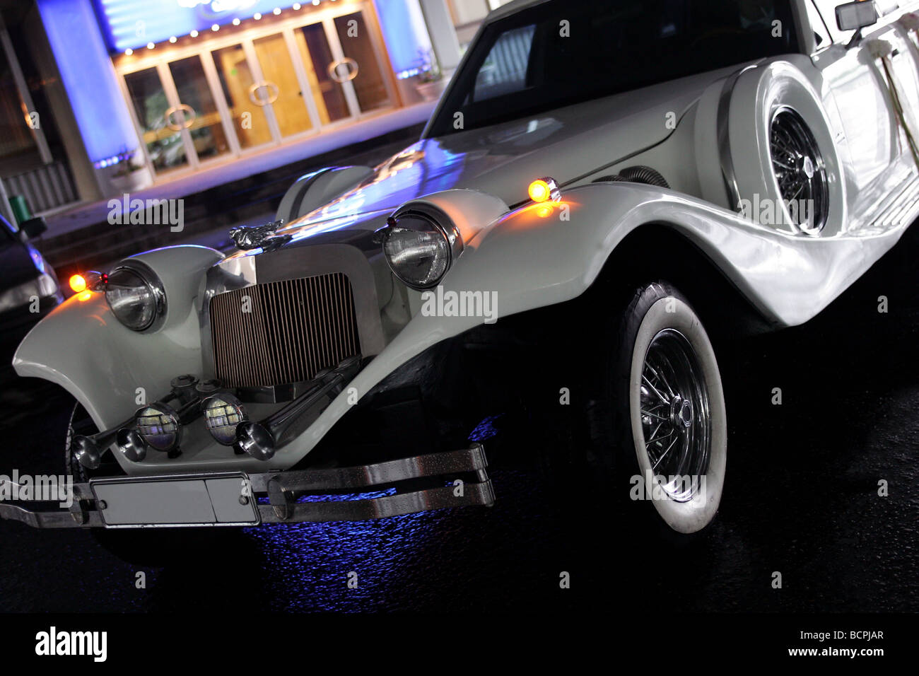 Vintage limousine parked outside city nightclub at night Stock Photo ...