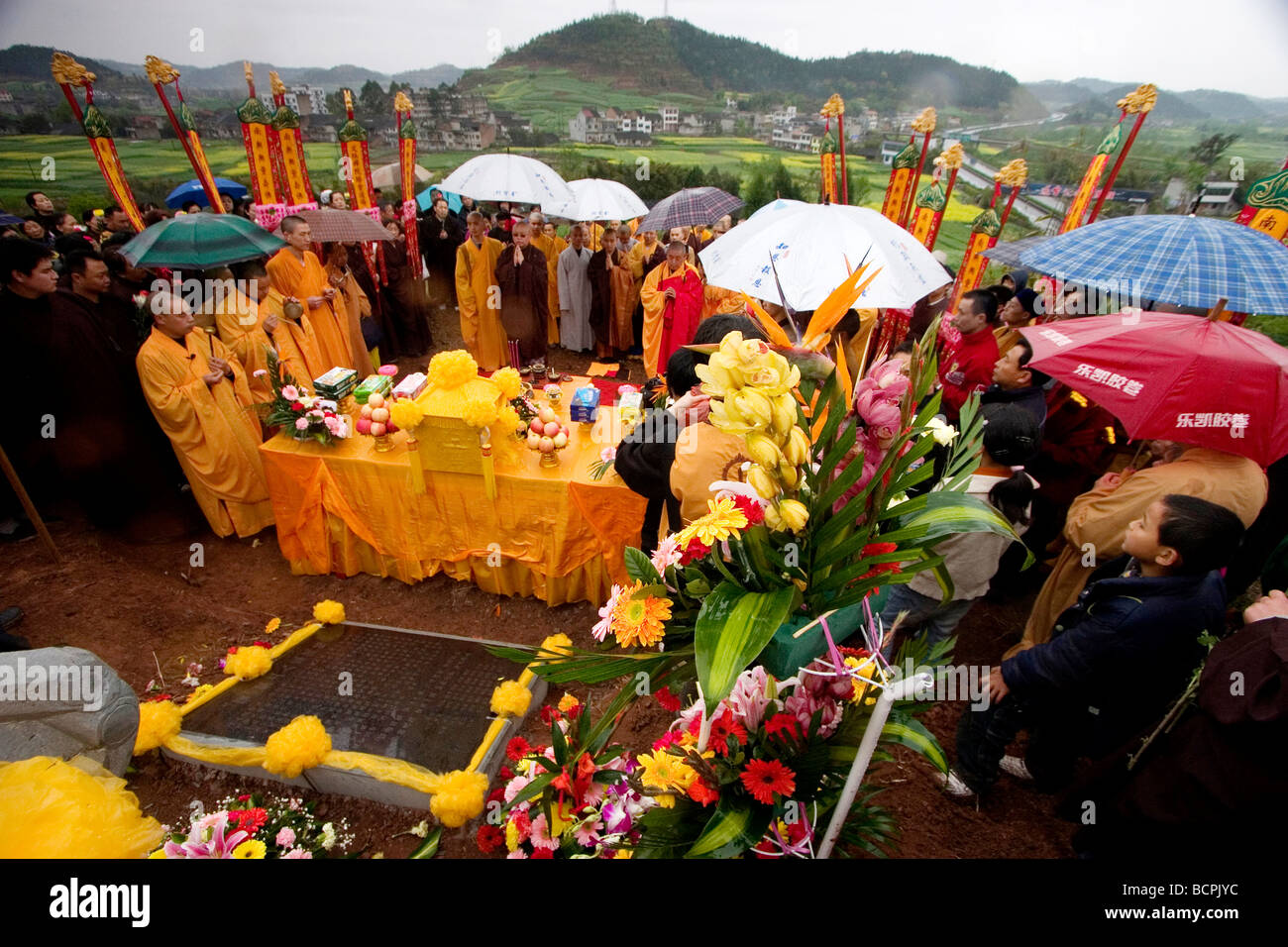 Buddhist monks performing ritual before elaborately decorated shrine on ...