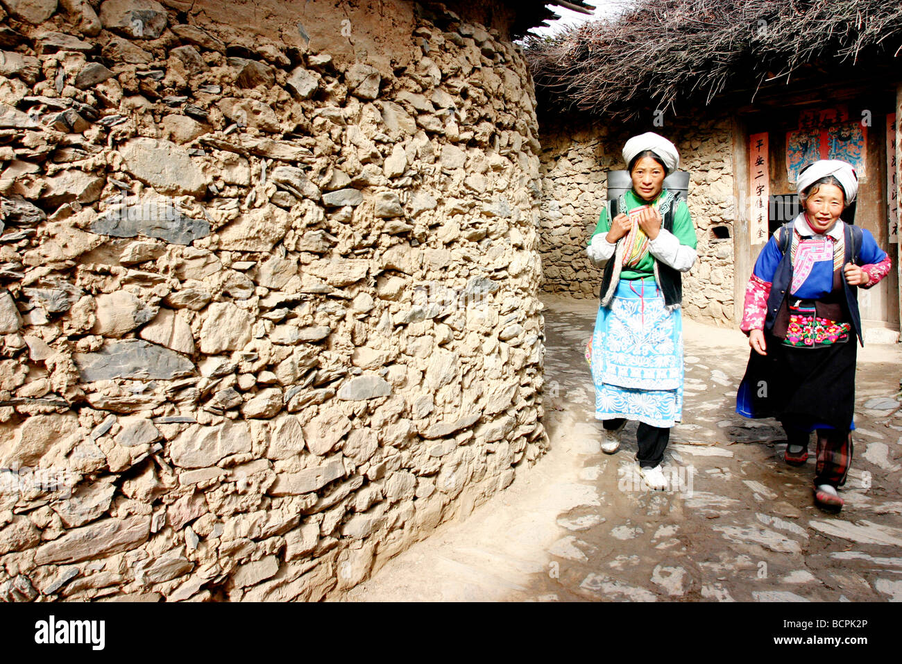 Qiang minority women in traditional clothing carrying water, Luobozhai ...