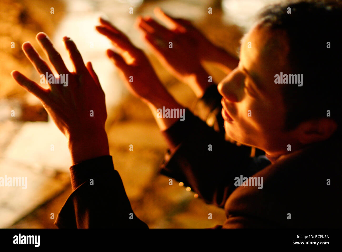 Qiang minority young man holding religious ritual before fire ...