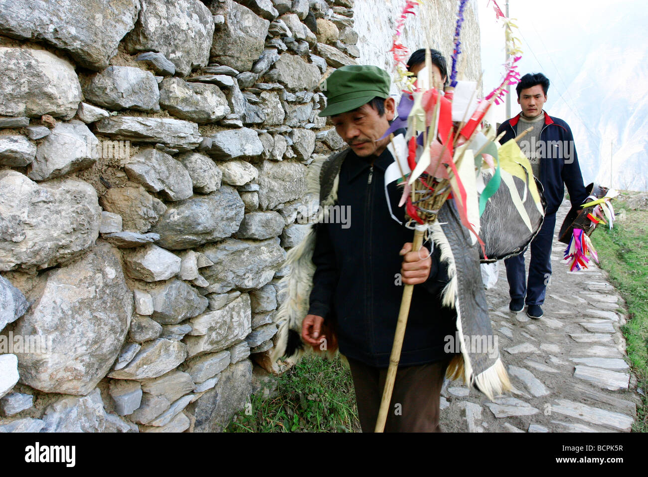 Priest on his way to conduct religious ritual, Luobozhai Village ...