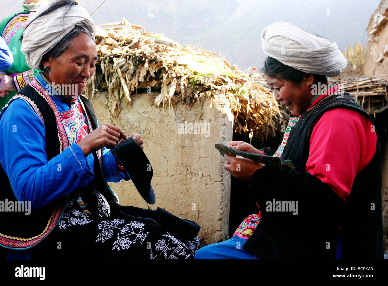 Qiang minority woman in traditional clothing making embroidery ...