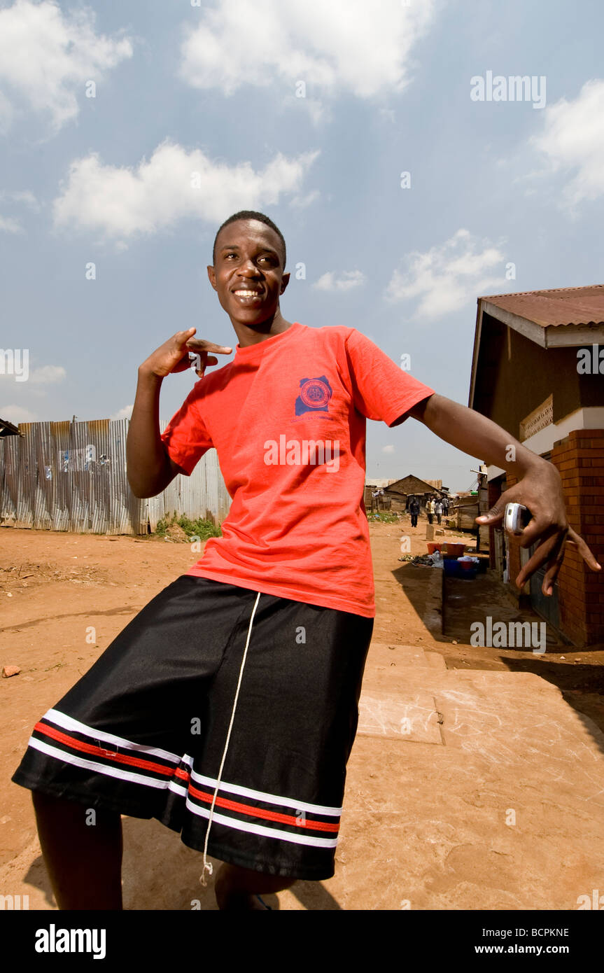 Young man in red t shirt dancing in hip-hop style on streets of Ugandan ...