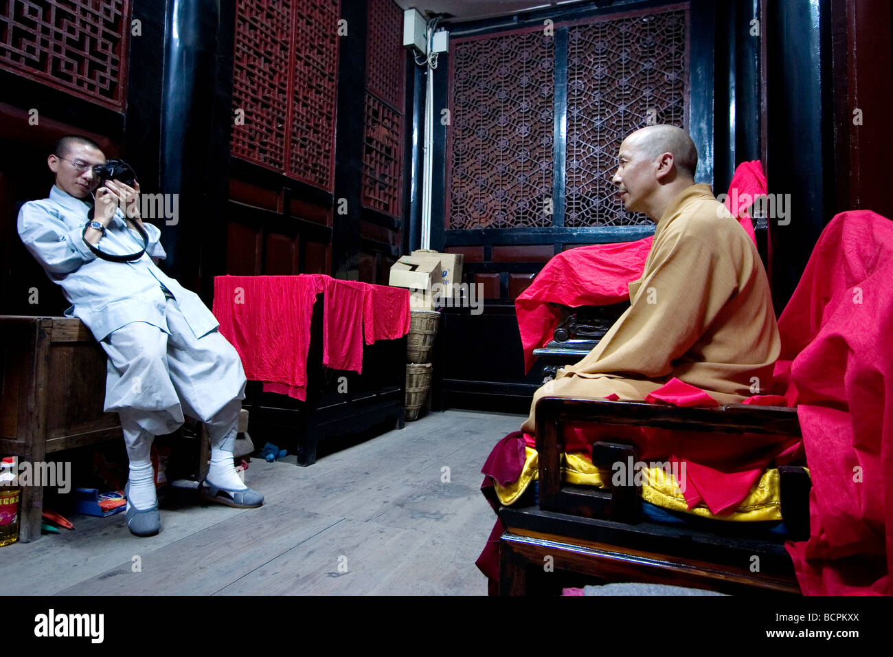 Monk taking picture of temple abbot using profession digital camera ...