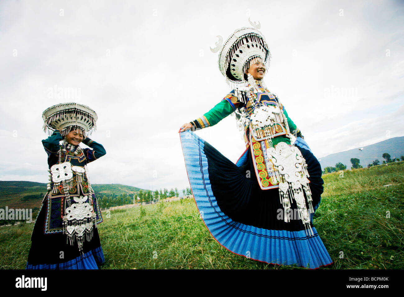 Two Yi Minority young women wearing elaborate festive costume during ...