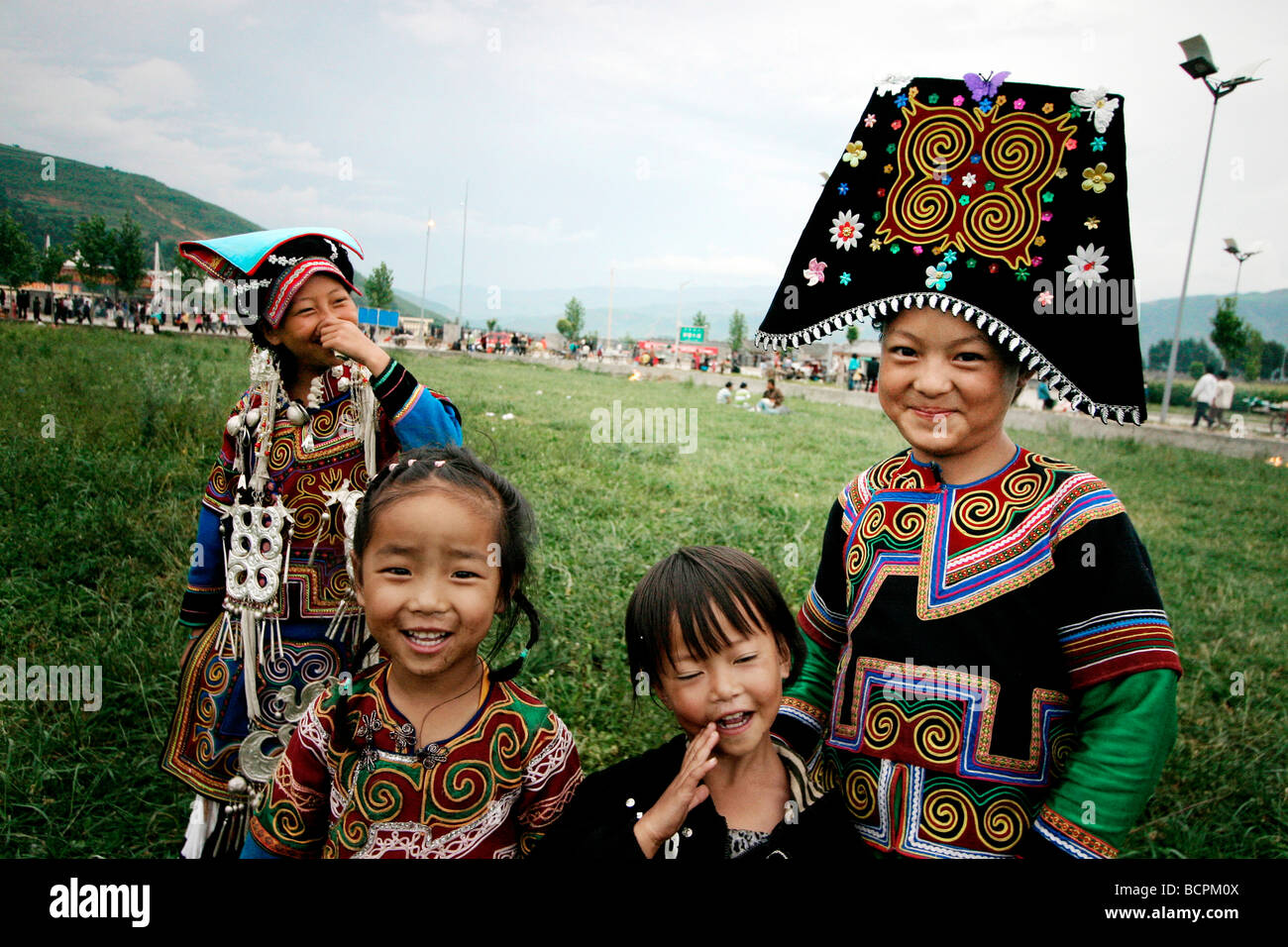 Yi Minority young women wearing elaborate festive costume during Torch Festival, Liangshan Yi ...