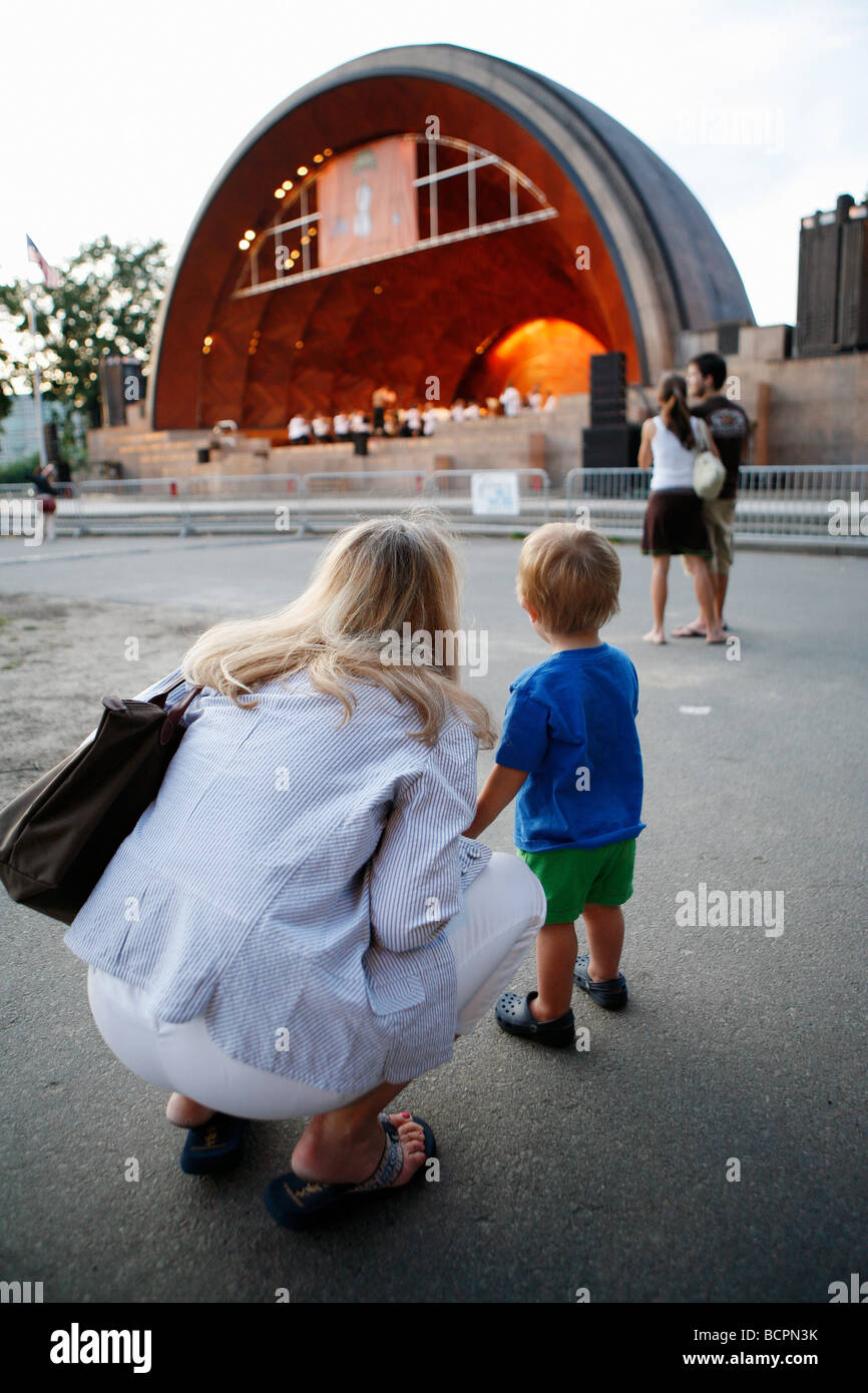 A woman and child watch a concert at the Hatch Shell on the Esplanade ...
