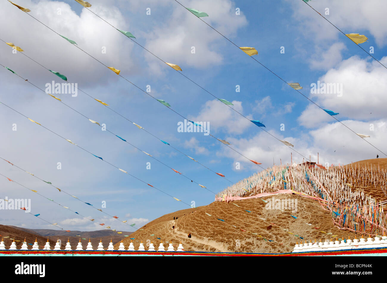 White pagodas and hill covered with prayer flags, Garzê Tibetan ...