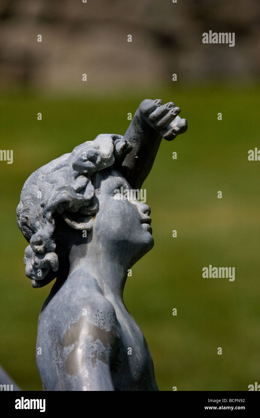 Statue of a boy looking up Stock Photo - Alamy