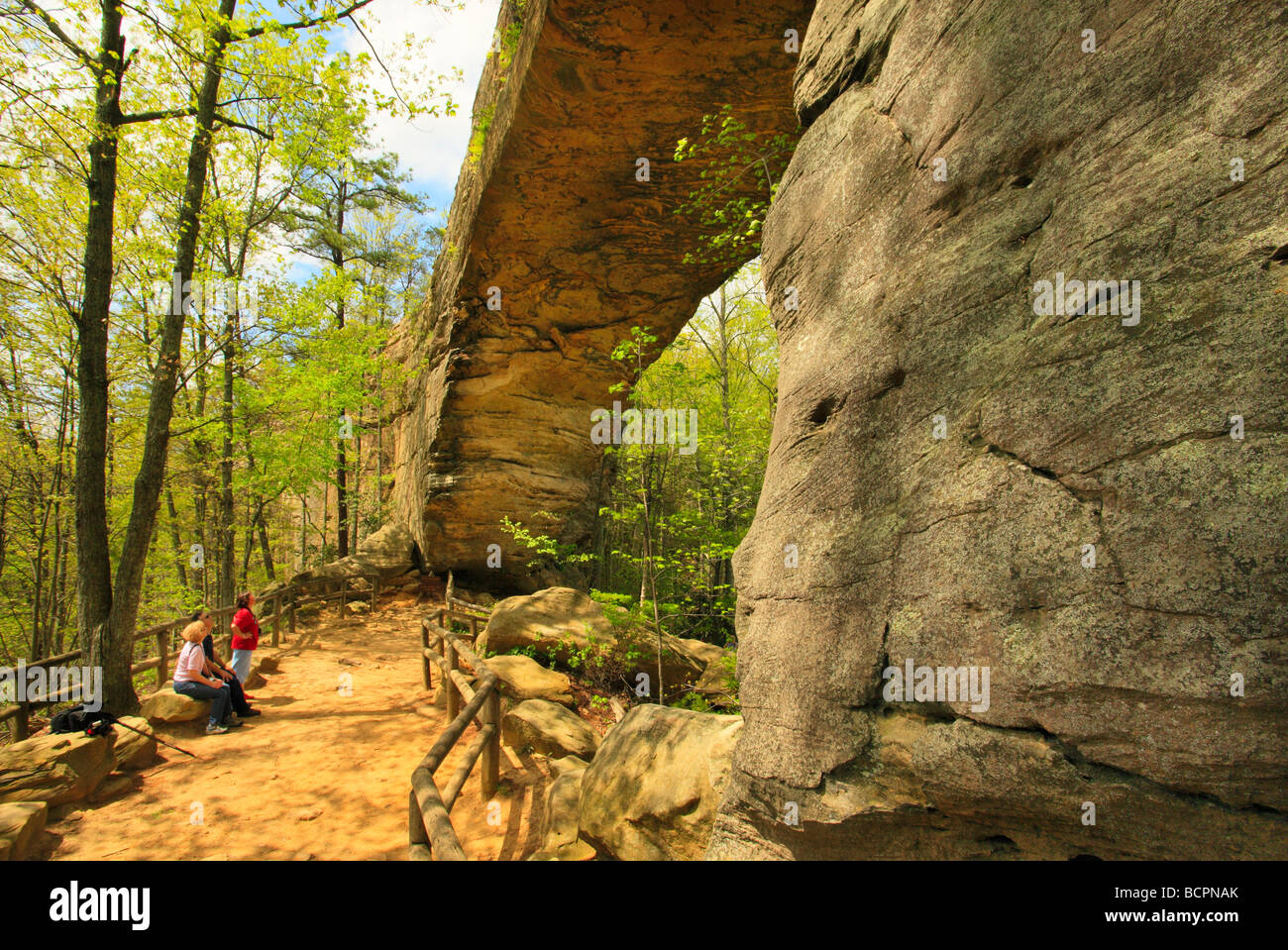 Hikers on trail beneath the Natural Bridge Natural Bridge State Resort ...