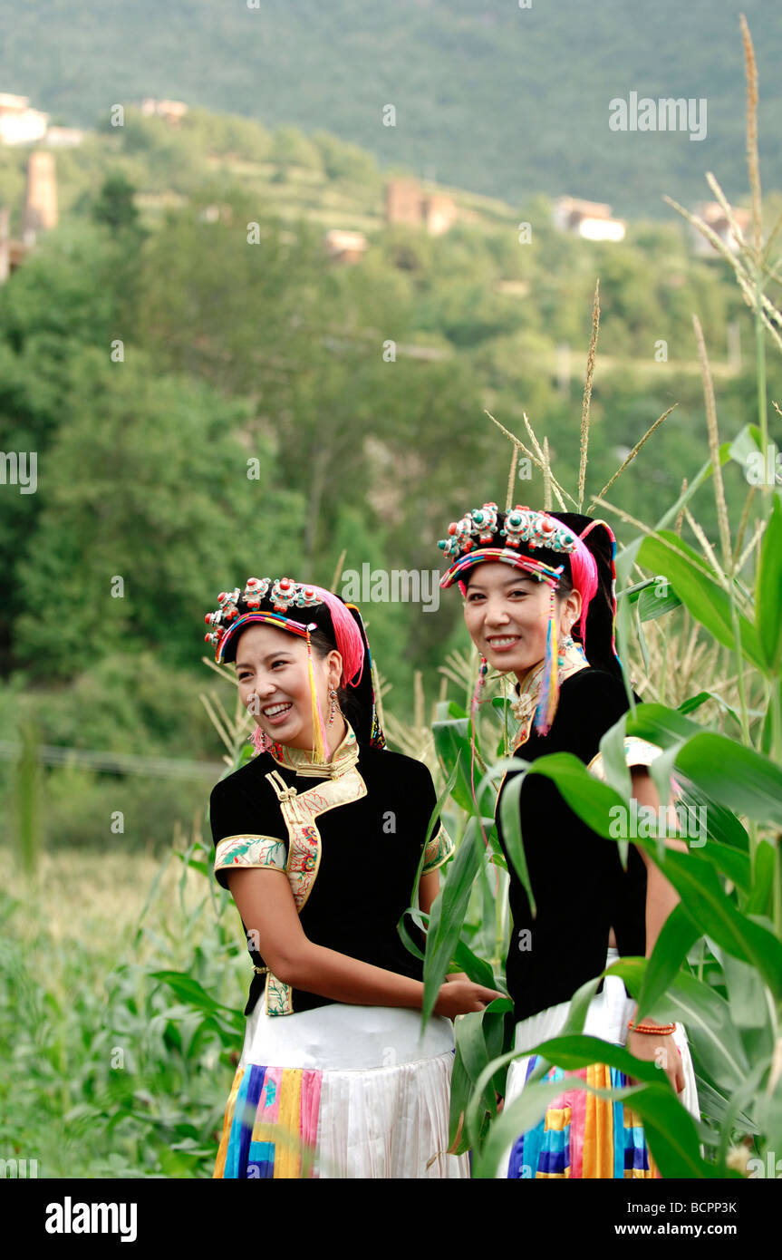 Two smiling Jiarong Tibetan young women wearing traditional headdress ...