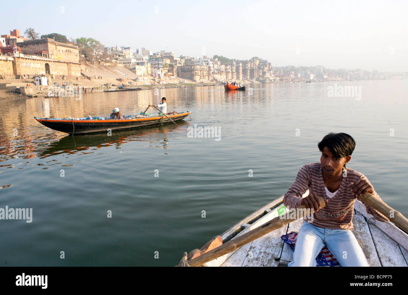 Young Indian Boy Rowing a Boat On The Ganges Varanasi India Stock Photo ...