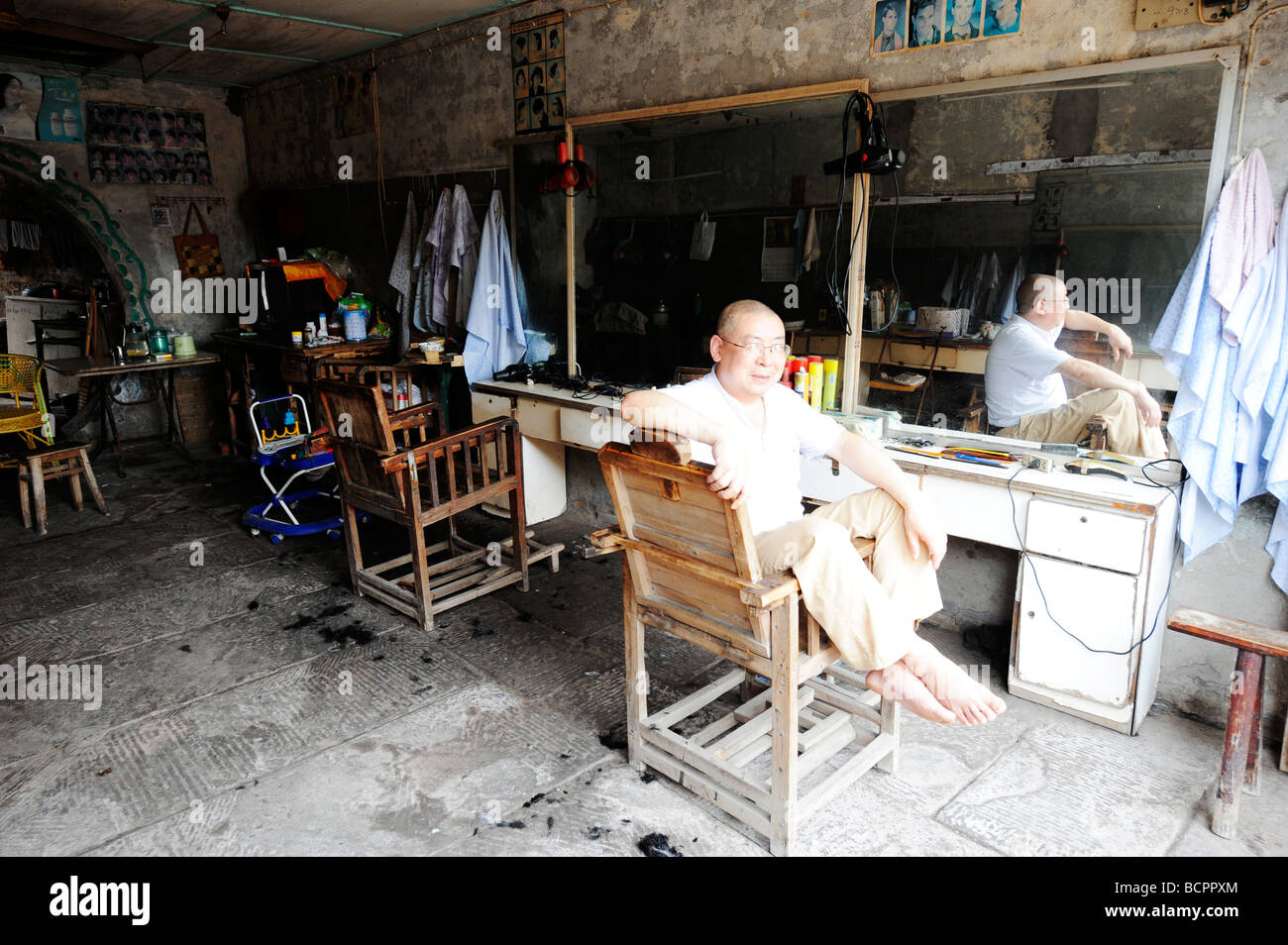 Old barber sitting in the barber chair, Fuxin Hair Barber Shop ...