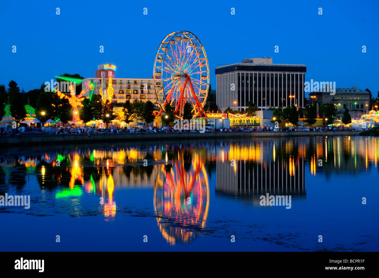 Lights from the Lakefair celebration reflect on Capitol Lake in Olympia ...