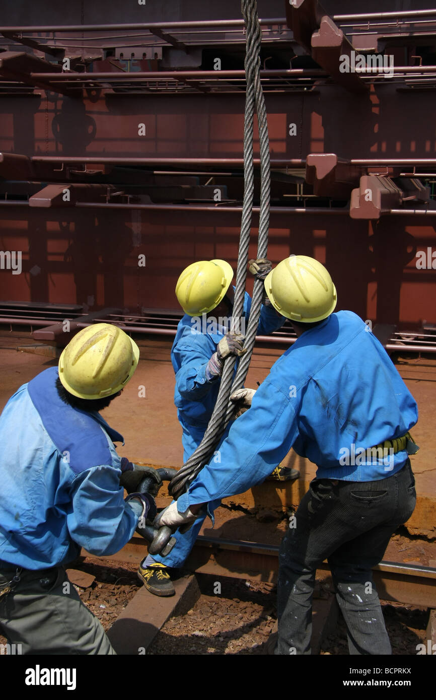 Workers pulling thick cables, Shipyard, Zhoushan Islands, Zhejiang ...