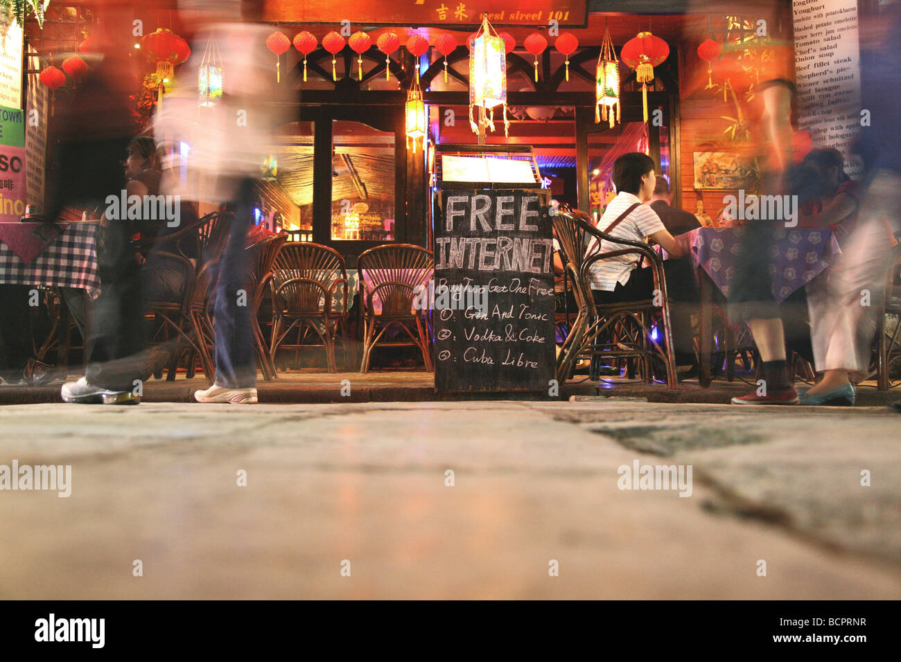 People buzzing outside of Jimmy Bar on West Street, Yangshuo City ...