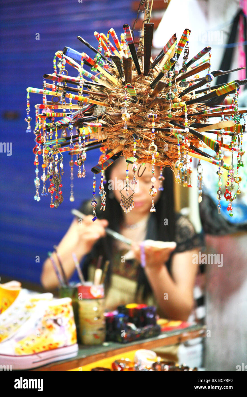 Colorful array of traditional Chinese hair ornaments on a straw hanging ...