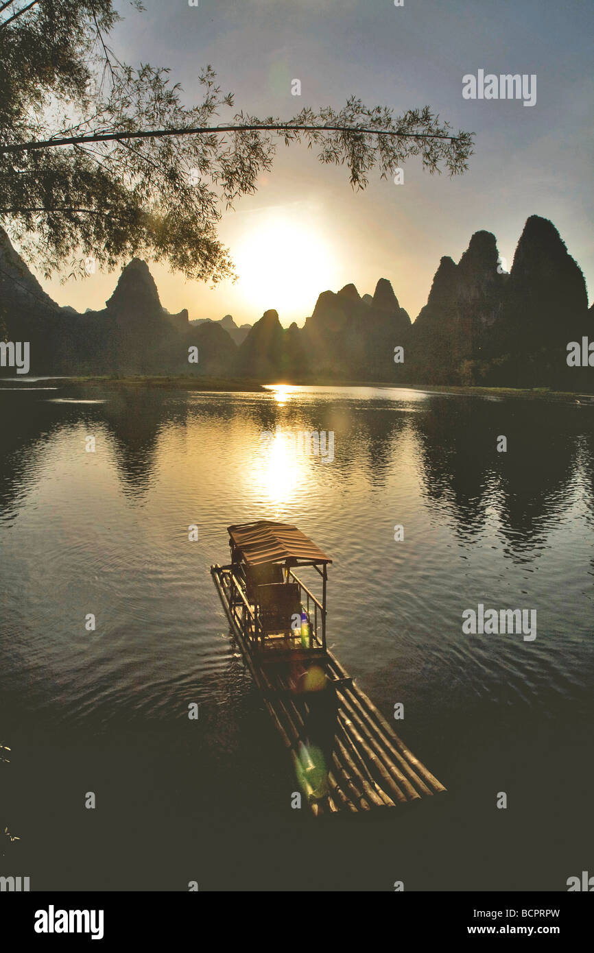 Empty bamboo tourist raft on Li River in sunset, Guilin City, Guangxi ...