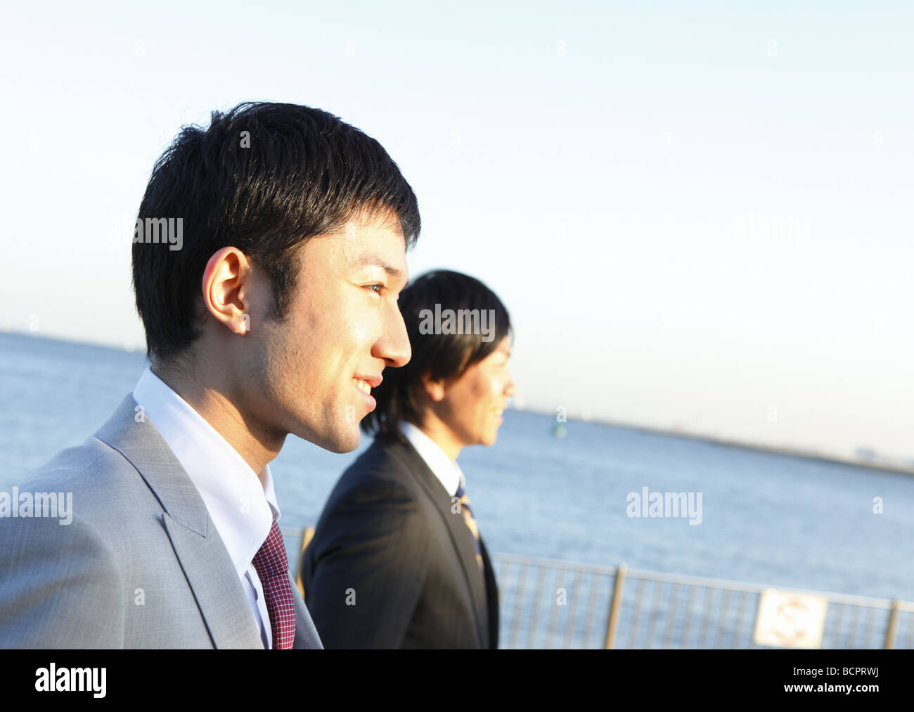 Businessmen looking into the far distance Stock Photo - Alamy