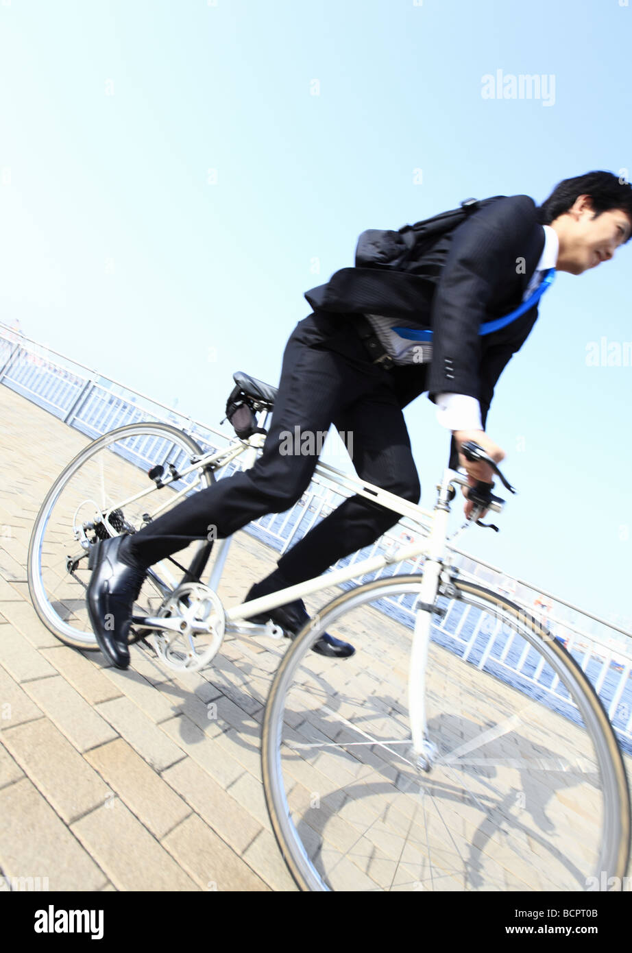 Businessman riding bicycle Stock Photo - Alamy
