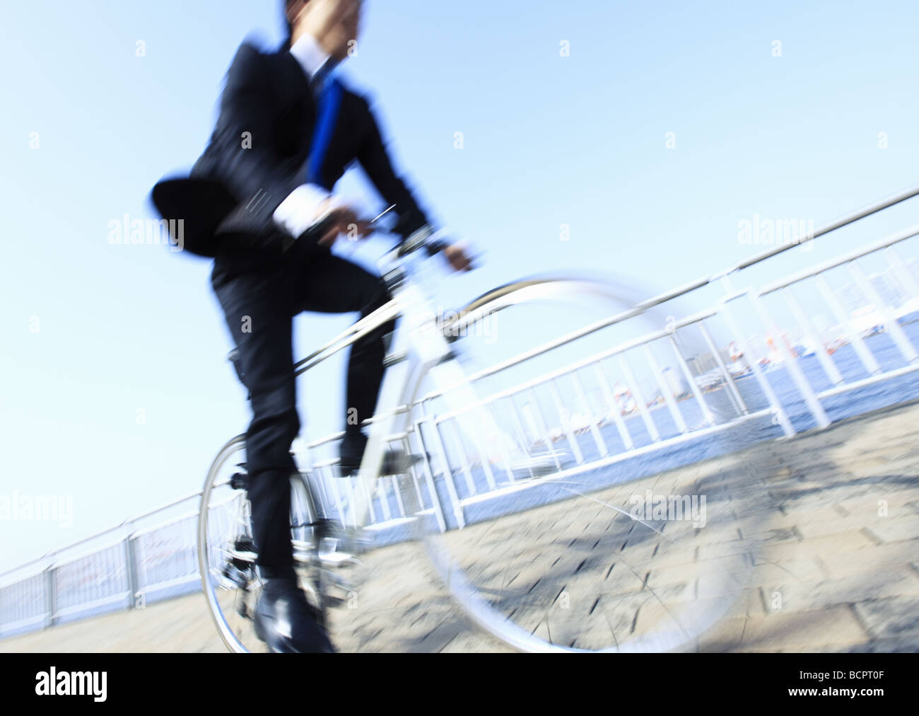Businessman riding bicycle Stock Photo - Alamy