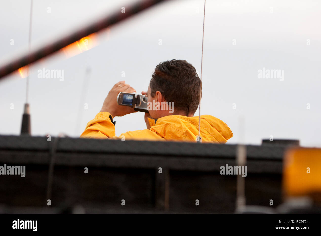 A researcher from Project Vortex 2 videotapes a distant storm near ...