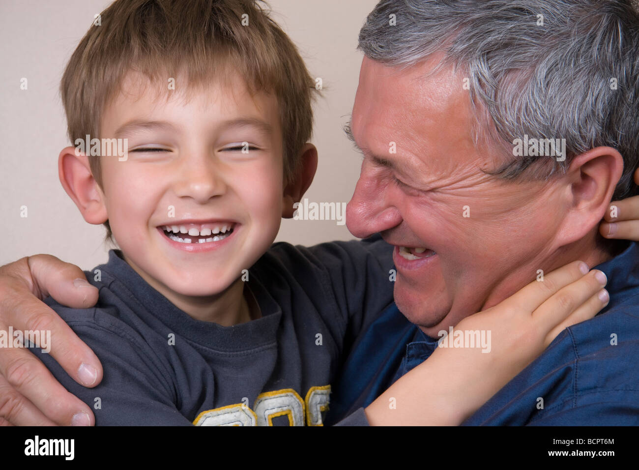 Boy giving his grandfather a huge hug Stock Photo - Alamy