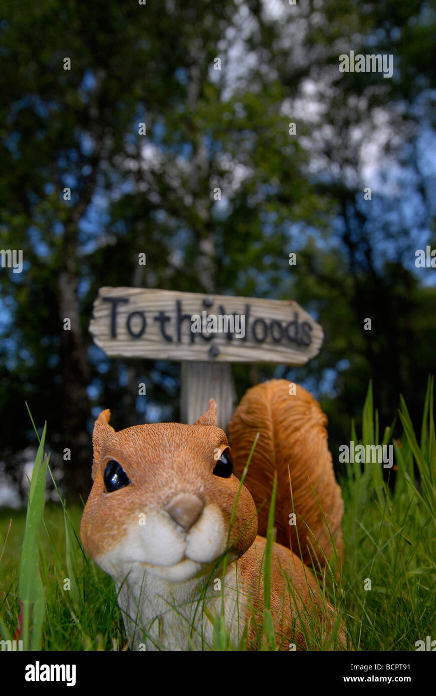 An artificial squirrel in the woods Stock Photo - Alamy