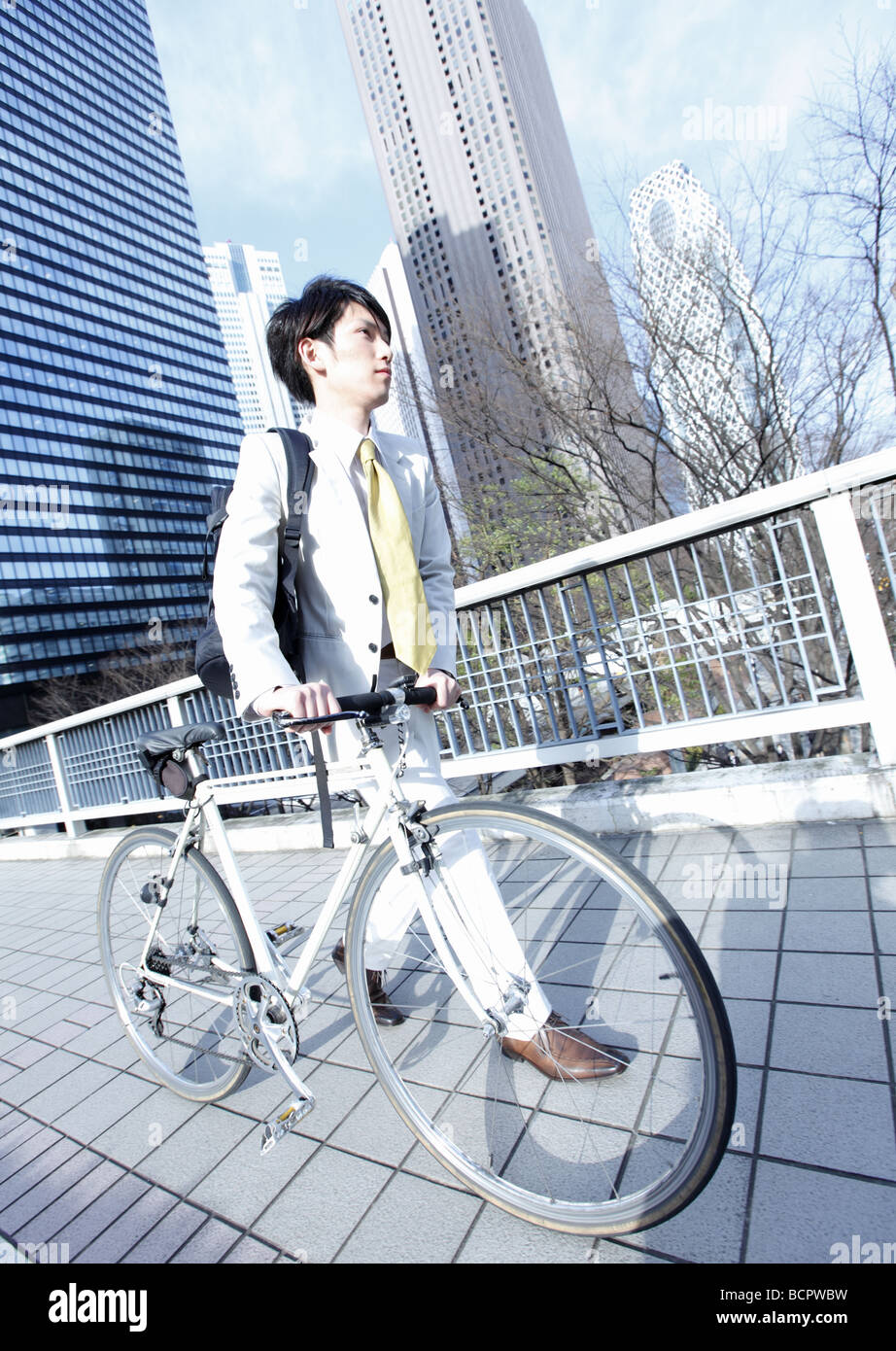 Businessman pushing his bicycle Stock Photo - Alamy